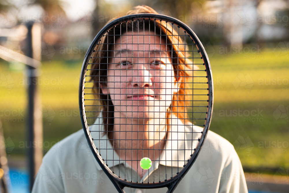 Image of tennis player with racquet in front of their face - Austockphoto