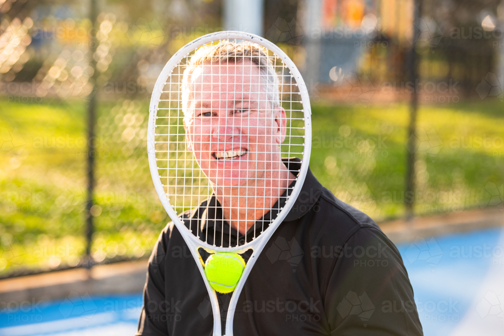 Image of tennis player with racquet in front of their face - Austockphoto