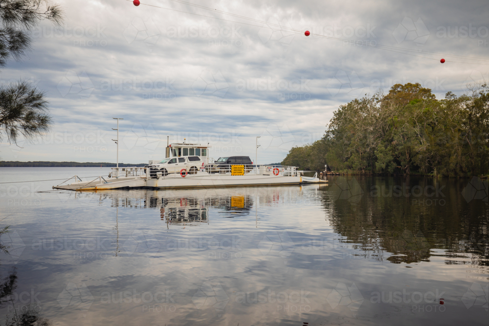 Image of The Bombah Point Ferry carrying vehicles across water ...