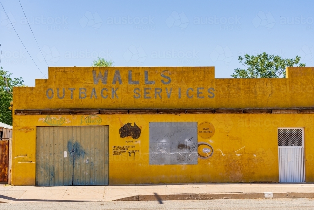 Image of The brightly painted facade of a mechanics garage in a rural ...