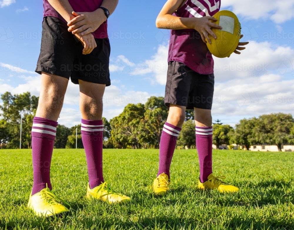 Image of the feet and legs of two children in football boots with ...