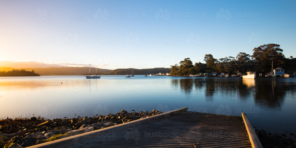 Image of The idyllic setting across Wagonga Inlet at sunset in Narooma ...
