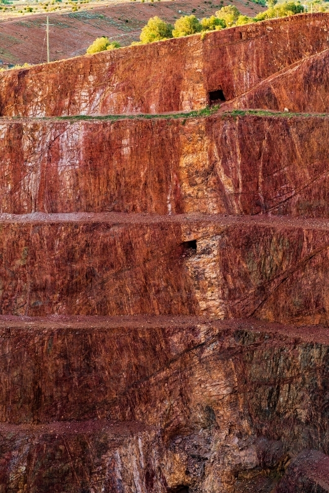 Image of The side wall of an open cut mine showing a vein of quartz ...