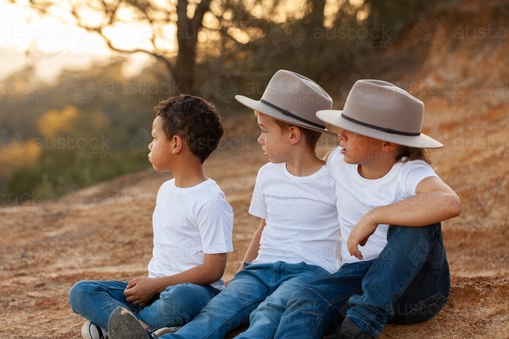 Image of Three aboriginal kids sitting together in rural Australia ...