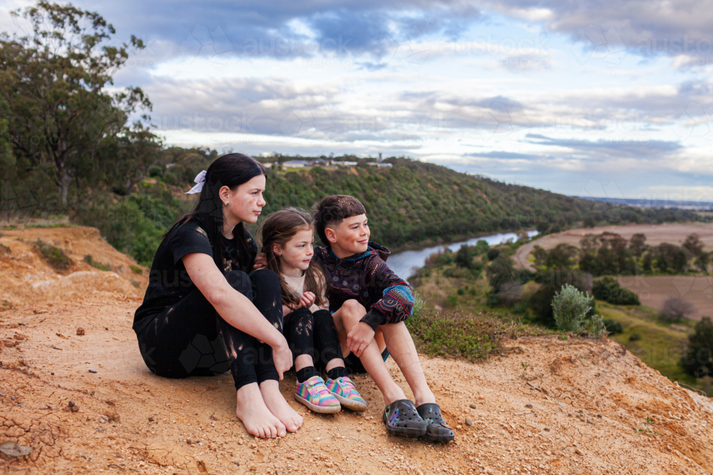 Image of Three aboriginal siblings sisters and brother sitting together ...