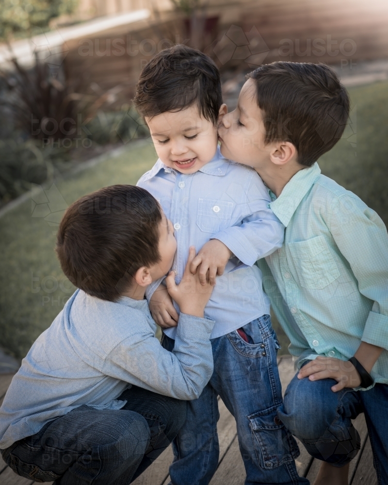 Image of Three brothers in a suburban home backyard - Austockphoto