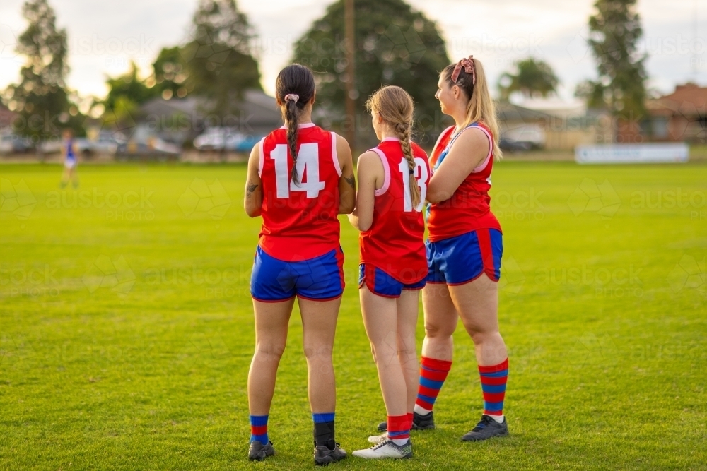 Image of three female teammates in football uniforms at training ...