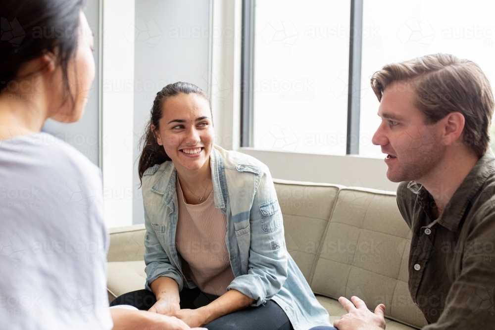 Image of Three happy office workers talking together in an industrial ...