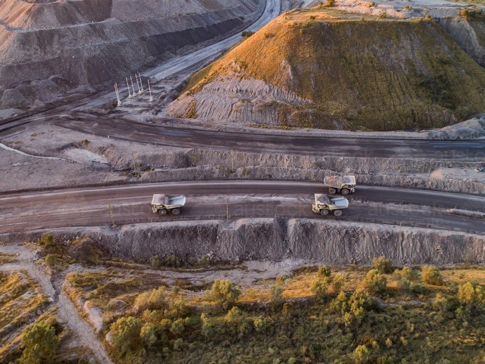 Image of Three mining dump trucks hauling coal in mine site in Hunter ...