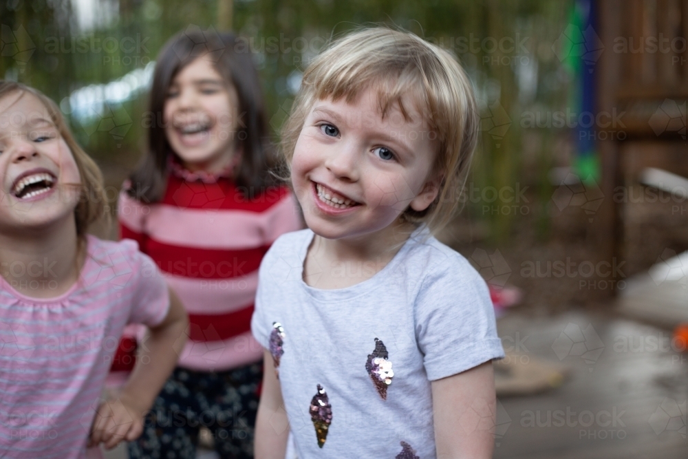 Image of Three pre-school friends laughing together - Austockphoto