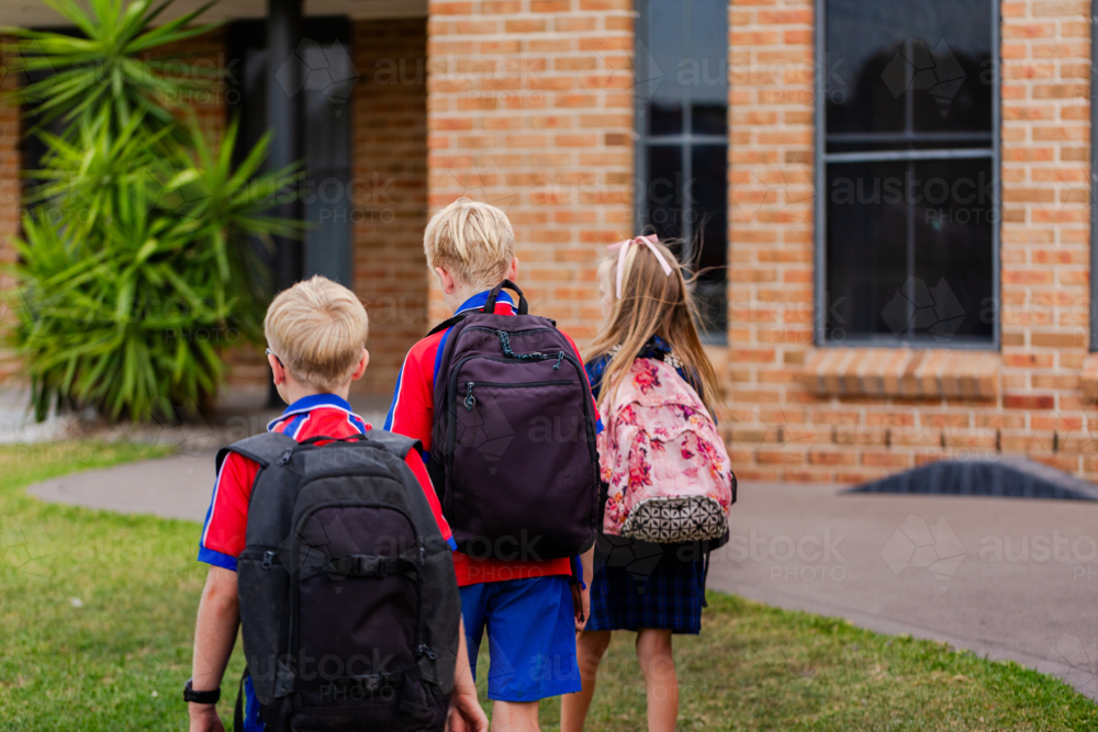 Image of Three public school siblings walking towards home from school ...