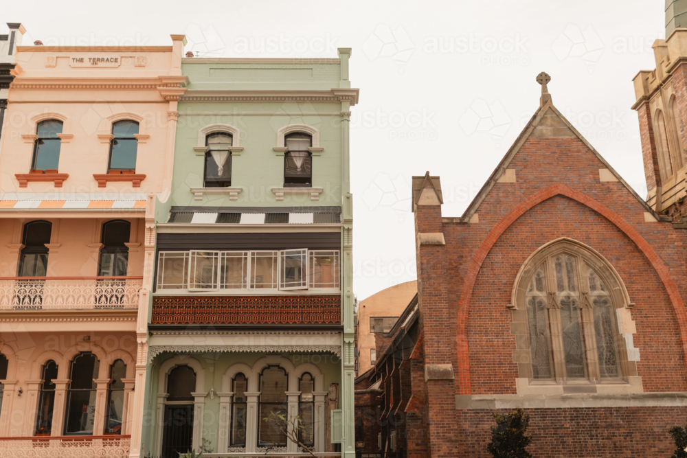 Image of Three storey terrace houses beside church in Newcastle city ...