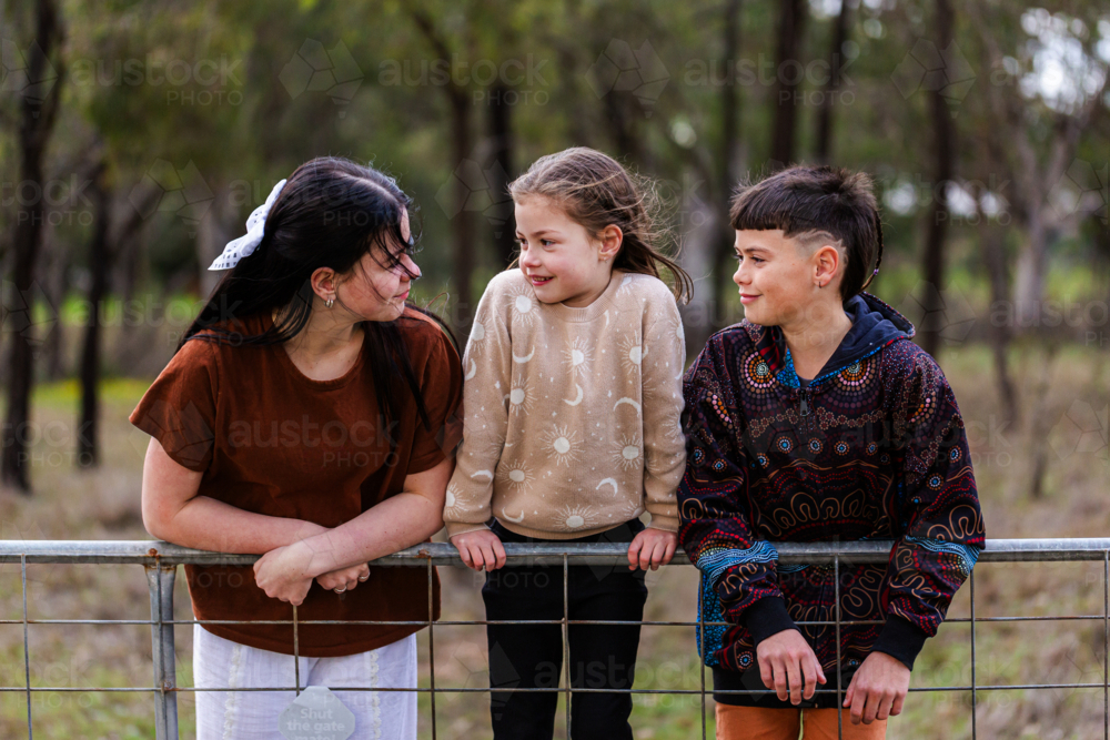 Image of Three Wonnarua Aboriginal siblings standing on gate together ...