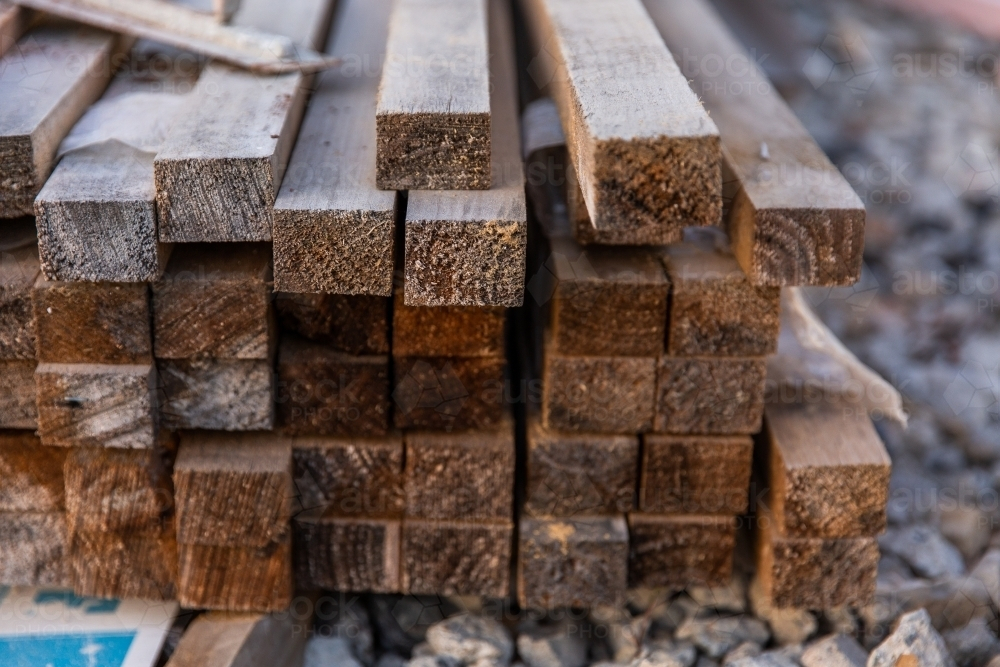 Image of timber stacked up on a construction site - Austockphoto