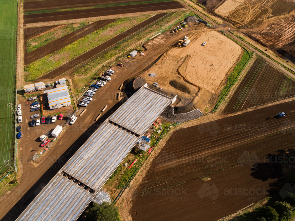 Image of tiny patch of agricultural farmland overshadowed by worksite ...