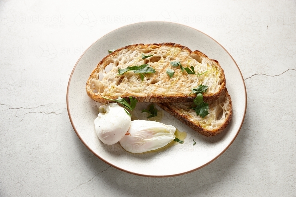 Image of toast bread with two poached eggs - Austockphoto