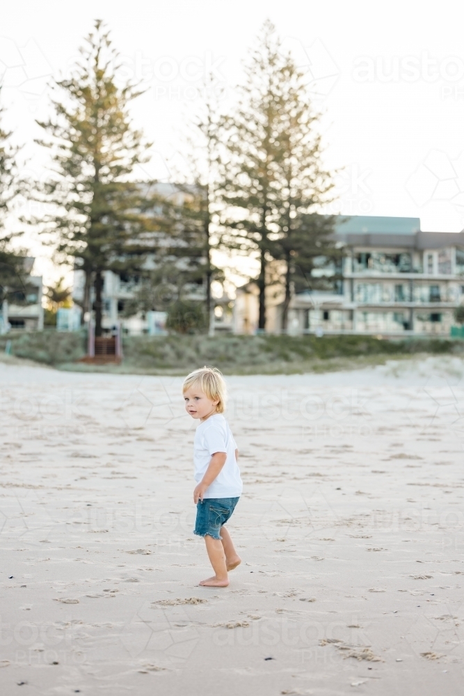 Image of Toddler boy exploring Golf Coast beach - Austockphoto