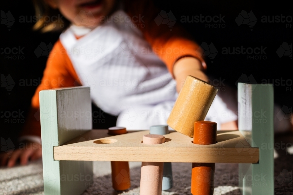 Image of Toddler child playing with hammer pounding bench toy in ...