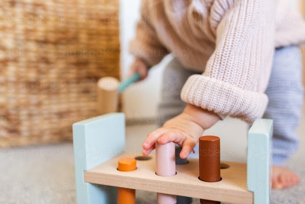Image of Toddler child playing with hammer pounding bench toy using ...