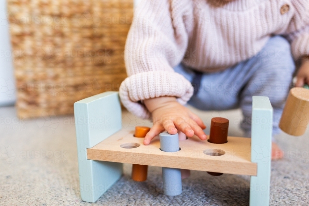 Image of Toddler child playing with hammer pounding bench toy using ...