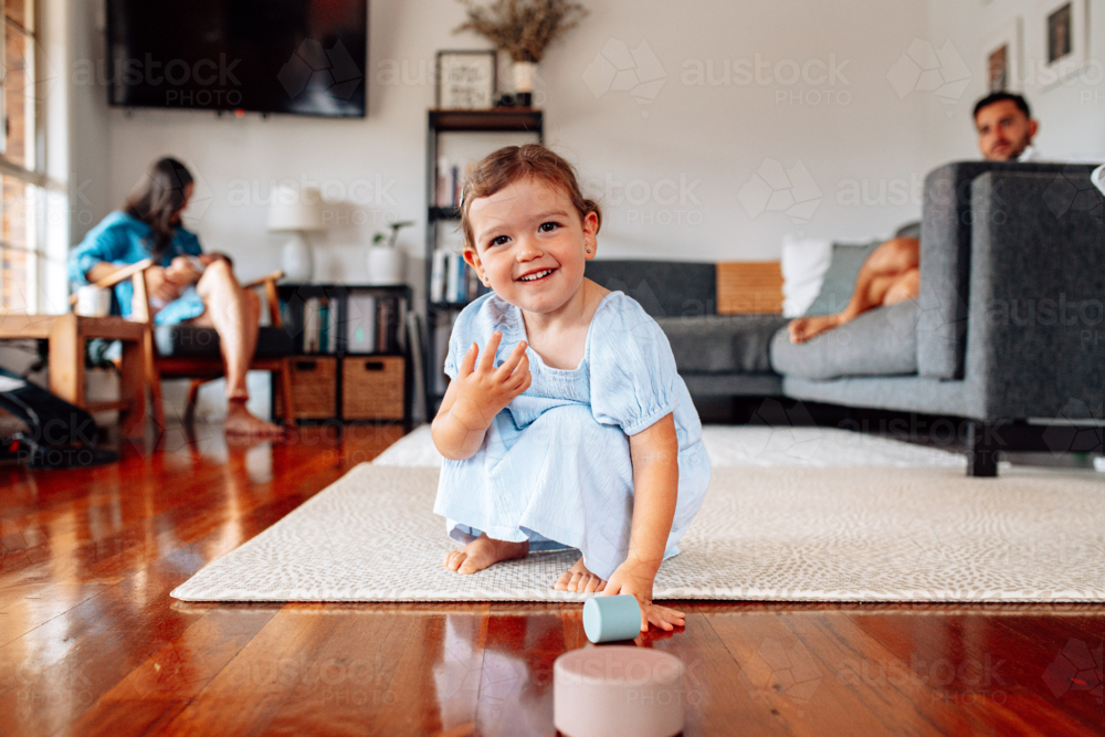 Image of Toddler girl building tower blocks on wooden floors ...