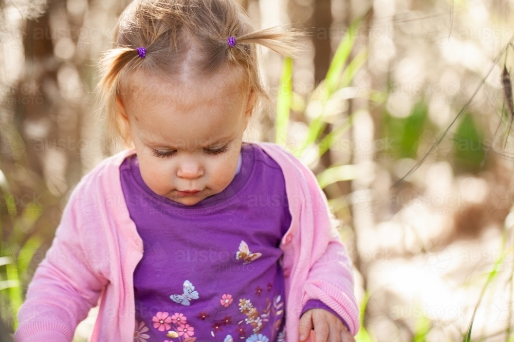 Image of Toddler girl exploring through nature outside in winter ...