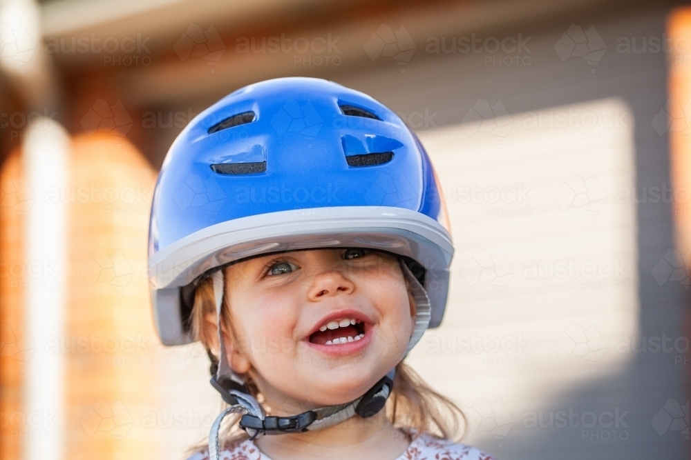 Image of Toddler girl with helmet on wonky over her eye - Austockphoto