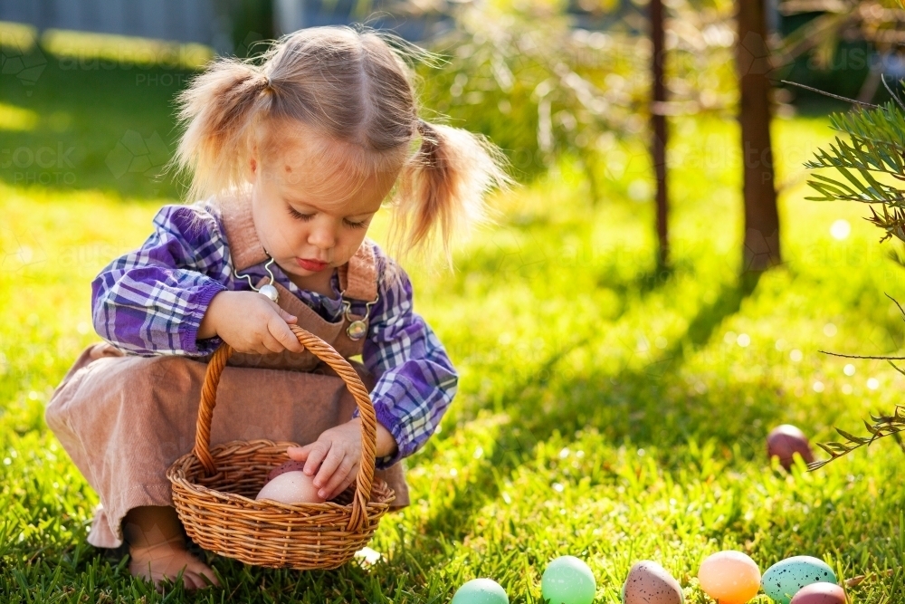 Image of Toddler in backyard on Easter morning hunting for eggs ...