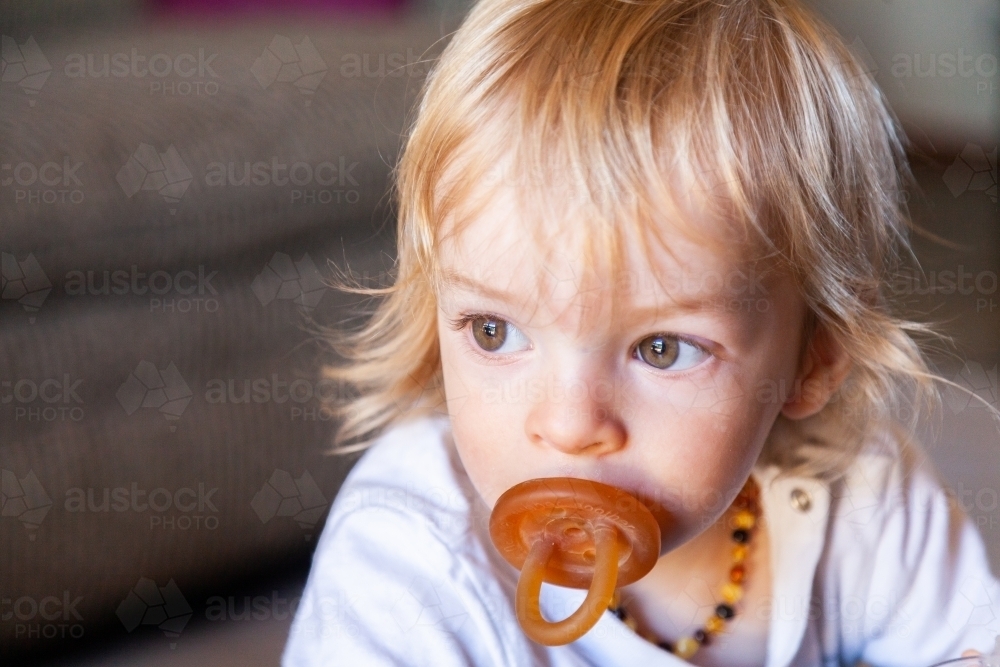 Image of Toddler with dummy - Austockphoto