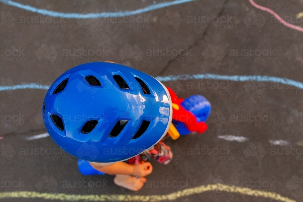 Image of Toddlers riding tricycle on driveway with chalk bike track ...