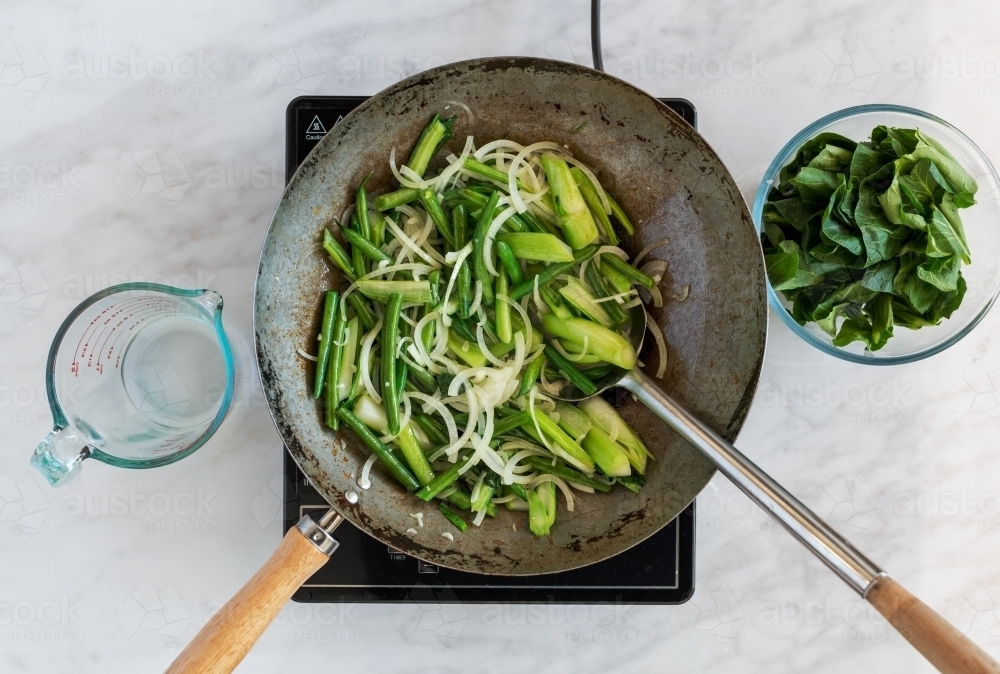 Image of Top down of stir fry ingredients and wok on marble - Austockphoto