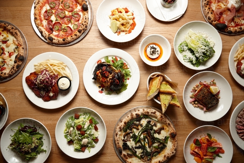 Image of Top down of various food dishes on table - Austockphoto
