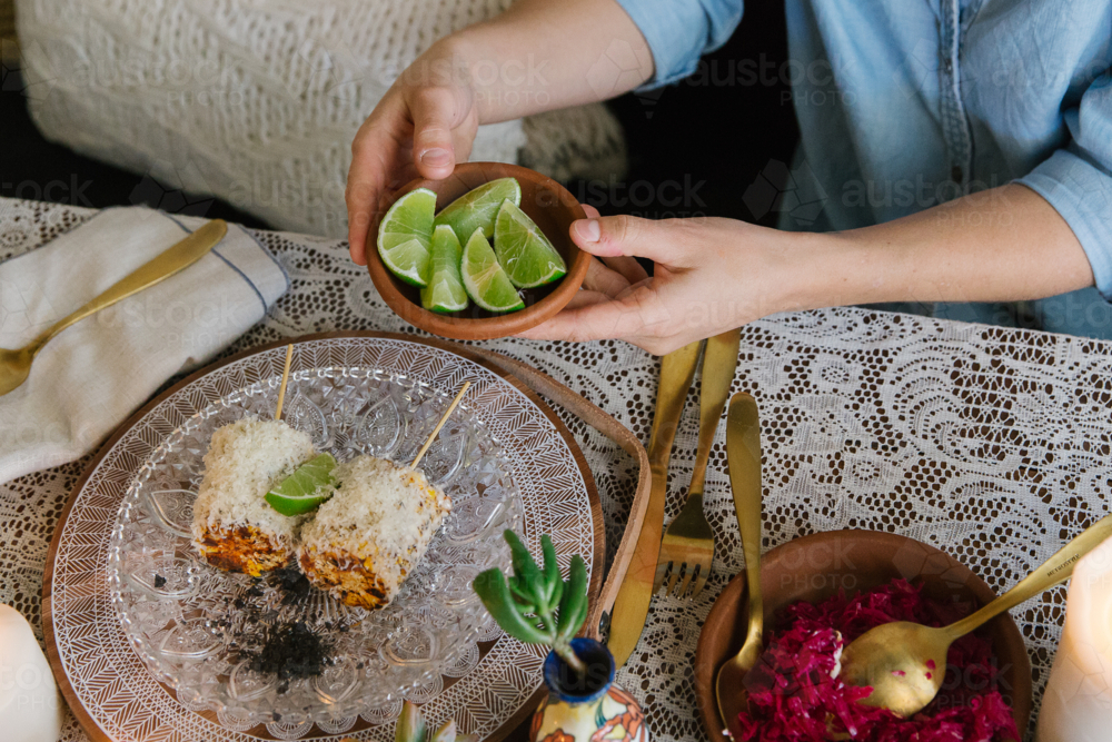 Image of Top-down view of a table with various food and woman holding a ...