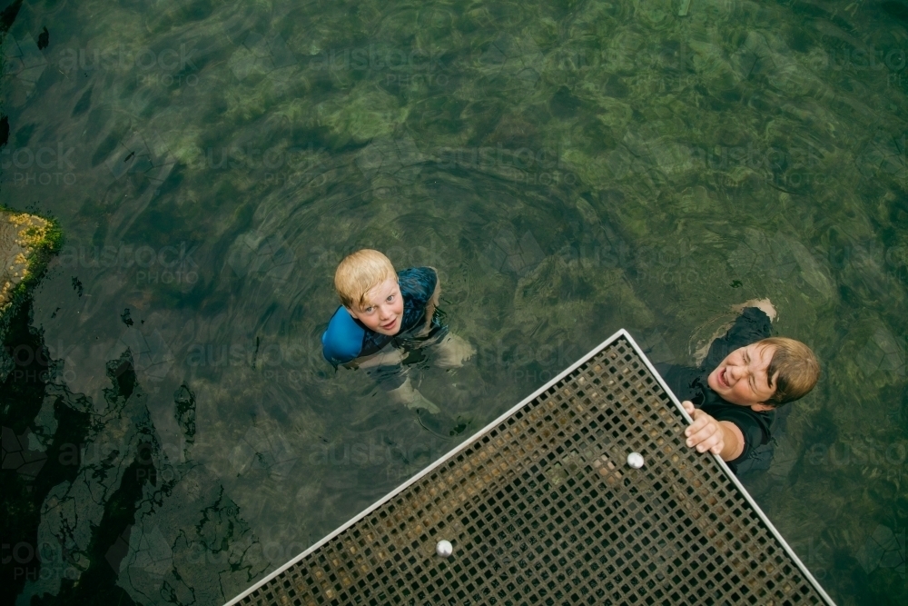 Image of Top view of kids swimming in clear blue water at the Bogey ...