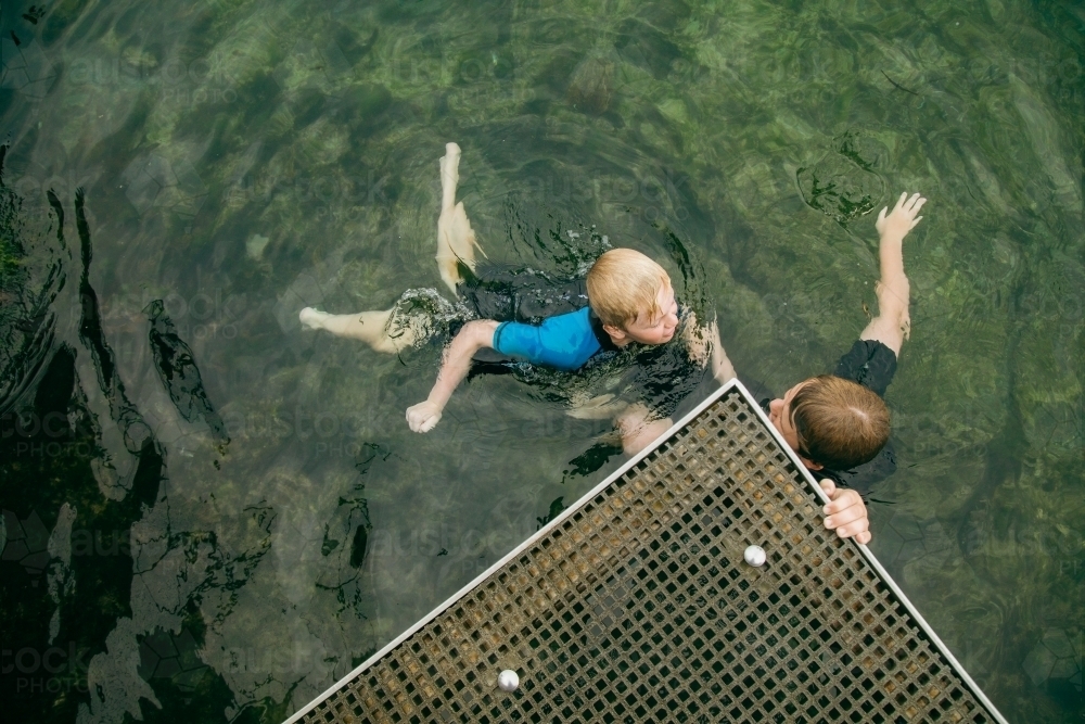Image of Top view of kids swimming in clear blue water at the Bogey ...
