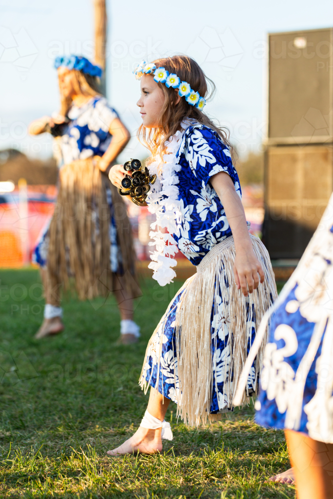 Image of Torres Strait Islander girl doing cultural dance at event wearing flower garland and ...
