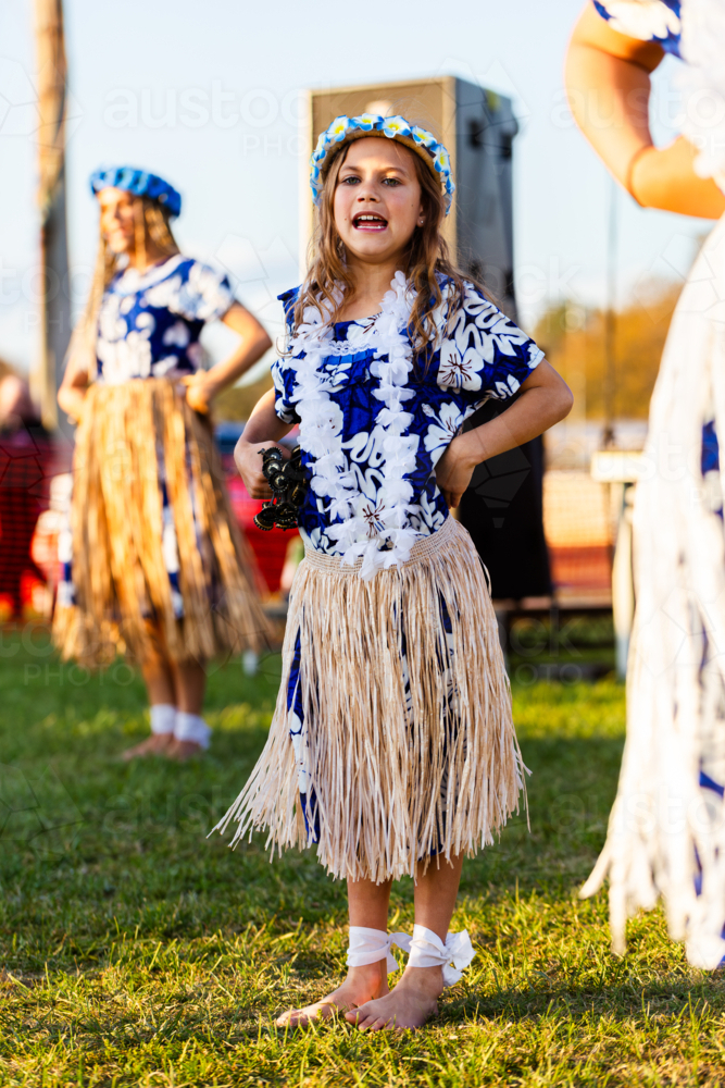 Image of Torres Strait Islander girl doing cultural dance at event wearing flower garland and ...