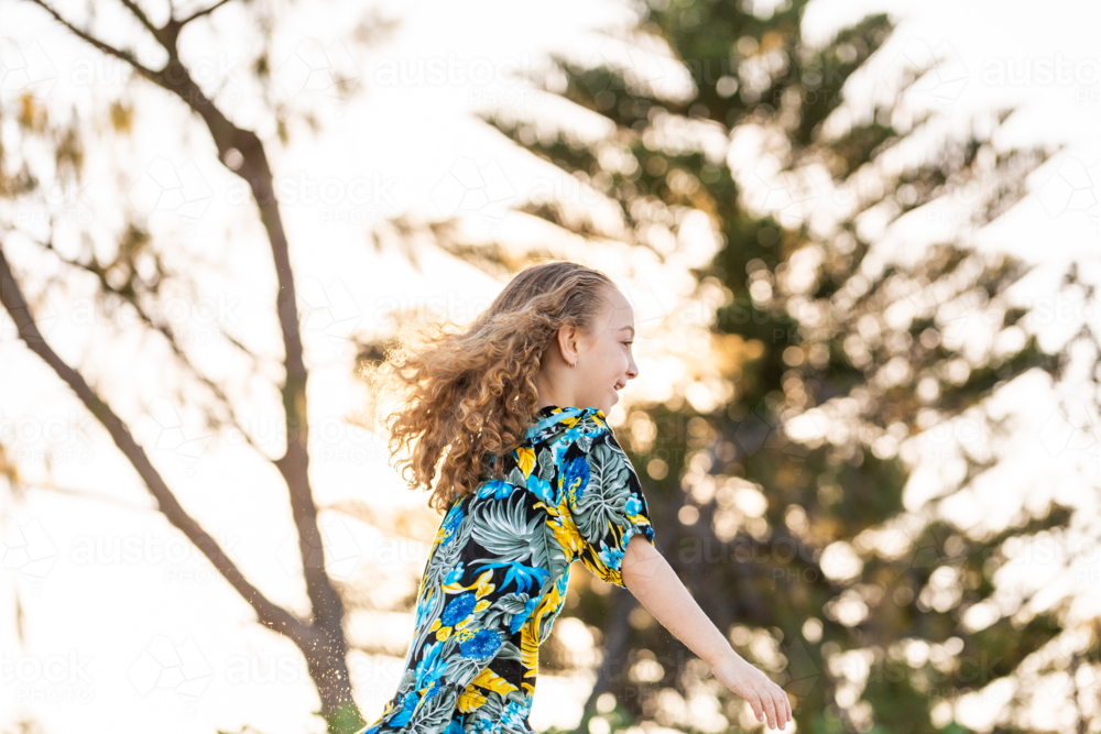 Image of Torres Strait Islander kid running past coastal trees at ...