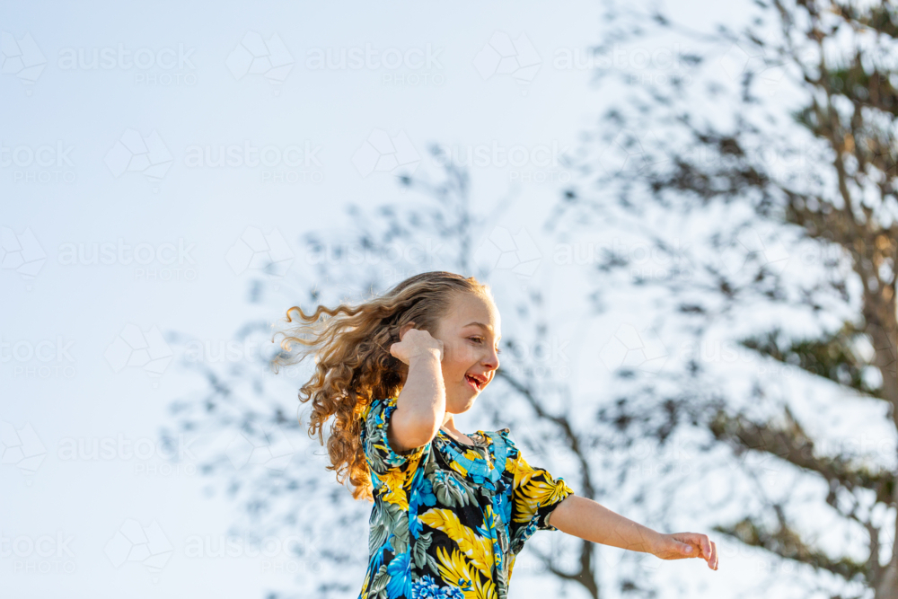 Image of Torres Strait Islander kid running past coastal trees at ...
