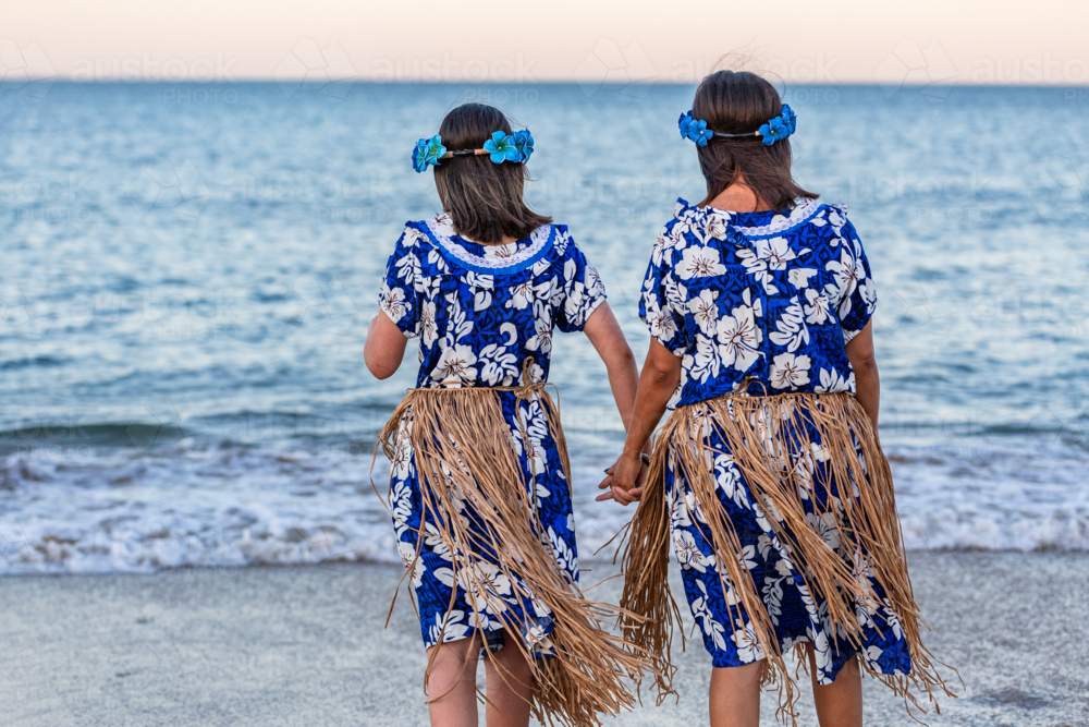 Image of Torres Strait Islander mother and teen daughter in traditional floral costume and skirt ...