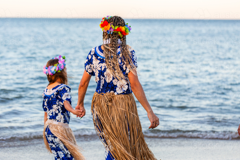 Image of Torres Strait Islander mother and young daughter in traditional floral costume and ...