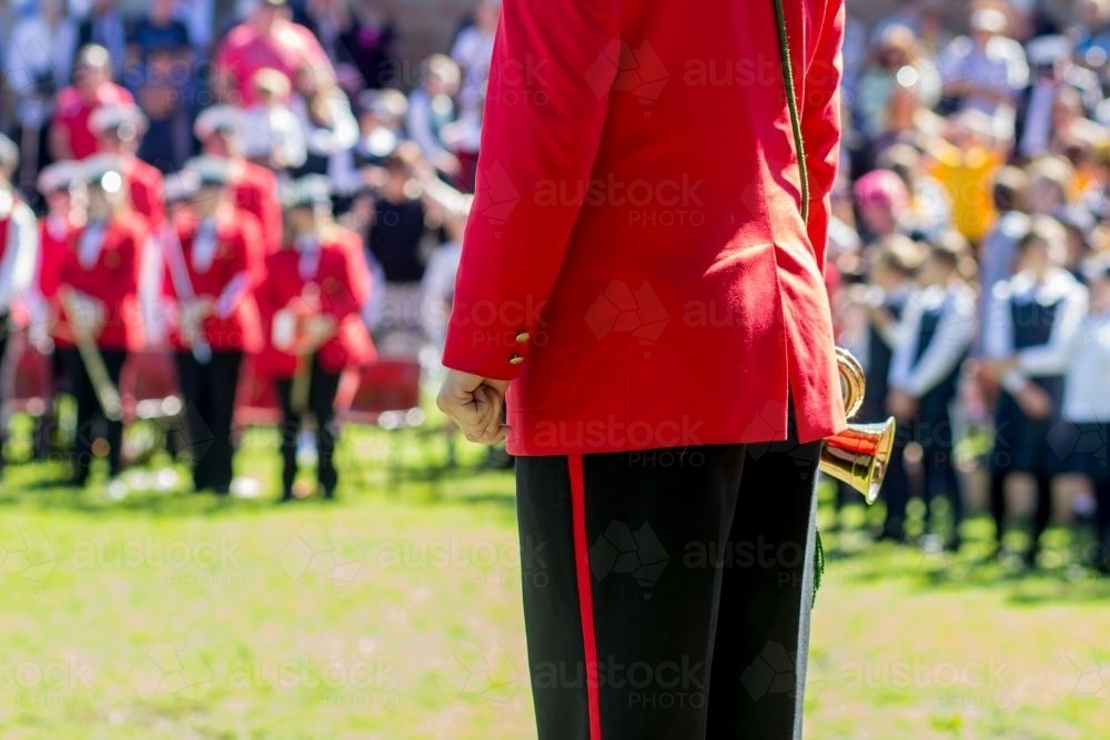 Image of Town band bugle player standing in front of crowd - Austockphoto