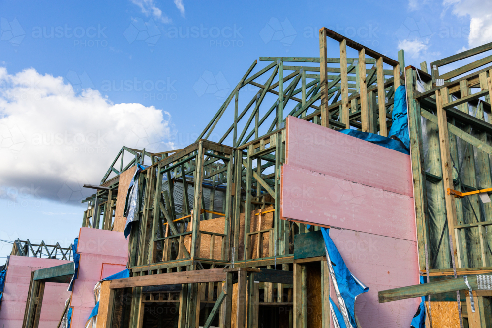 Image of town house under construction with timber frames - Austockphoto