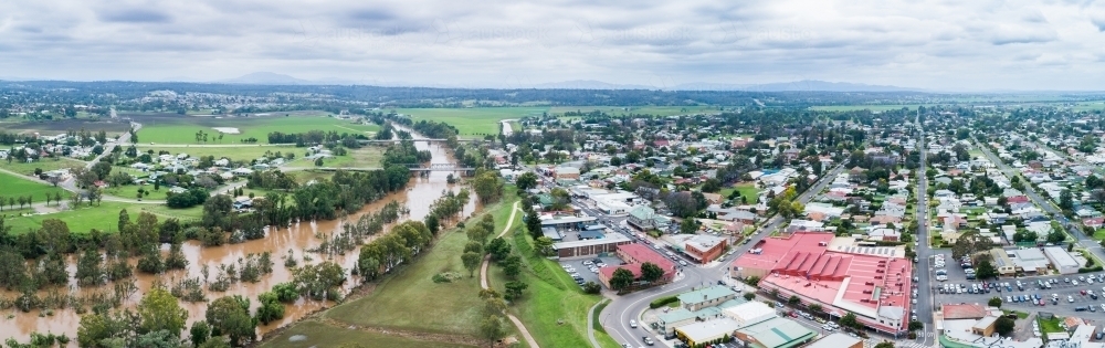 Image of Town of Singleton beside flooding river with brown floodwaters ...