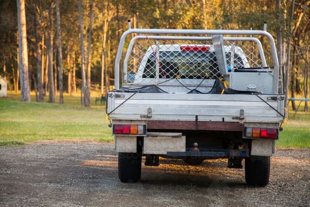Image of Trades persons work ute parked in backyard - Austockphoto