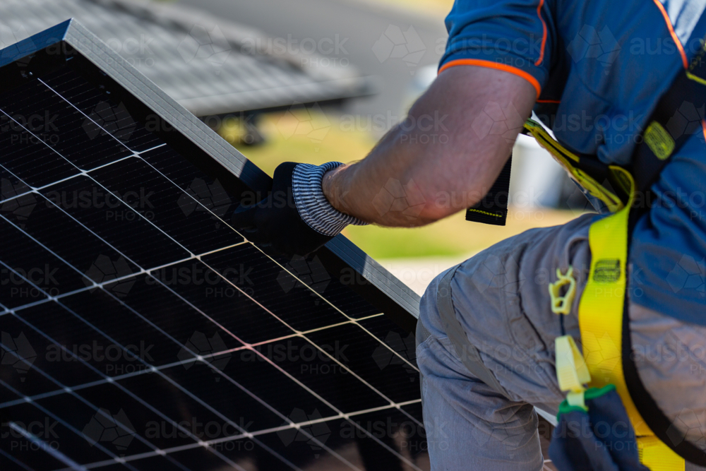 Image of Tradesman electrician installing solar panel system on rooftop ...
