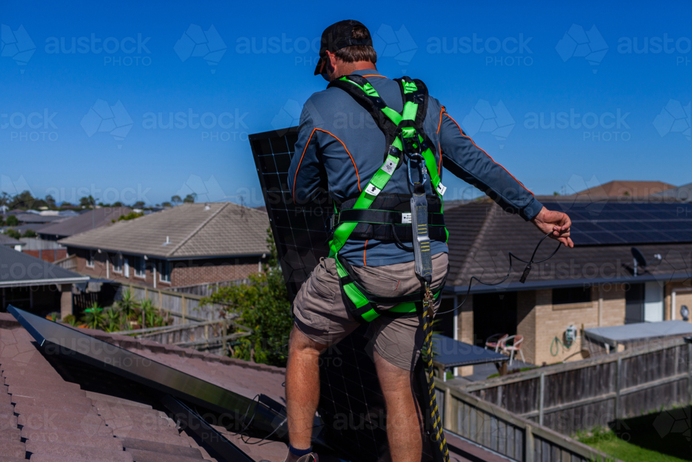 Image of Tradesman electrician with black bi-facial solar panels on ...