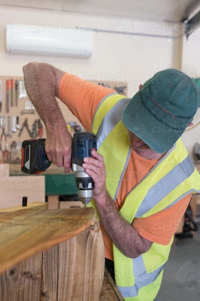 Image of Tradie using a drill - Austockphoto