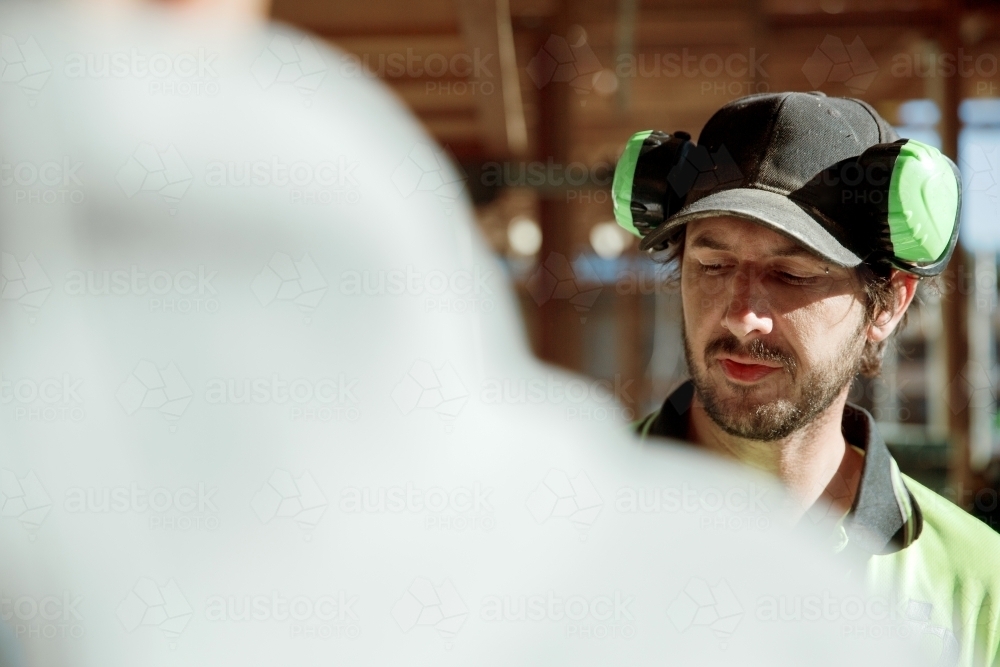 Image of Tradie working on construction site - Austockphoto