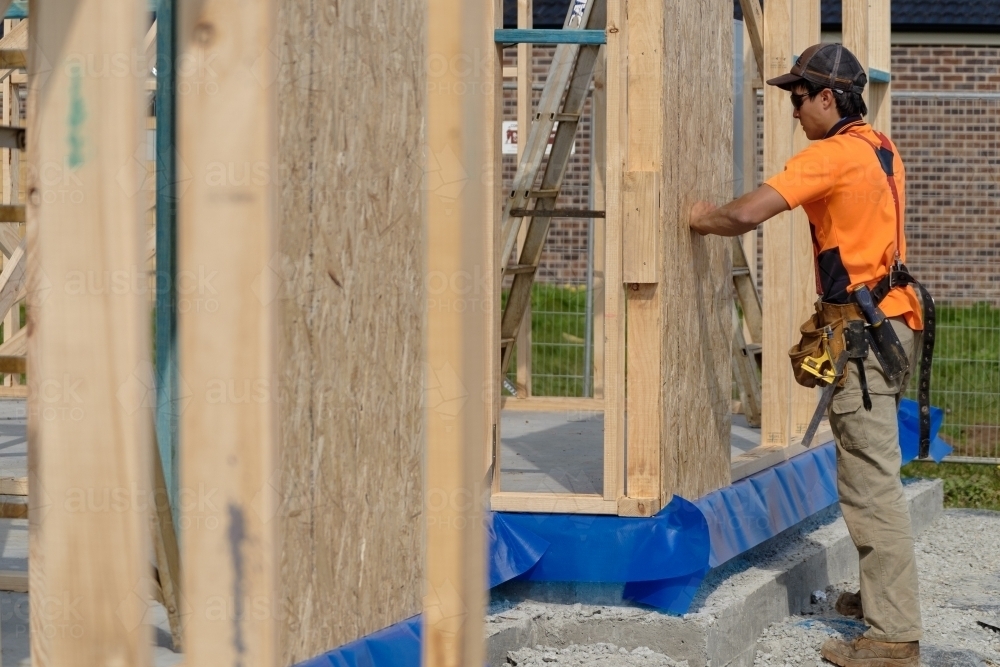 Image of Tradie working on house building site - Austockphoto
